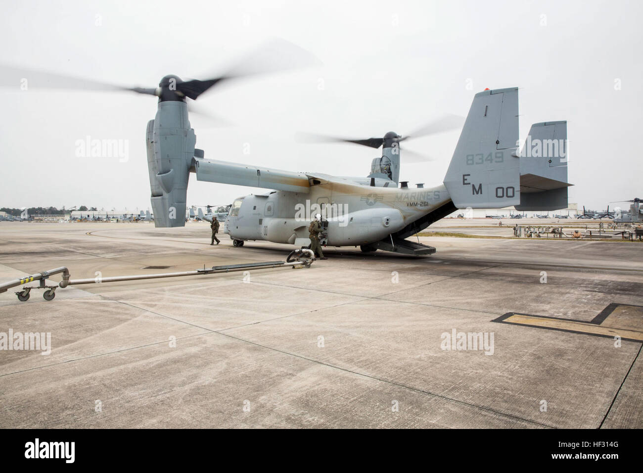 A crew chief with Marine Medium Tiltrotor Squadron 261 fuels an MV-22B ...