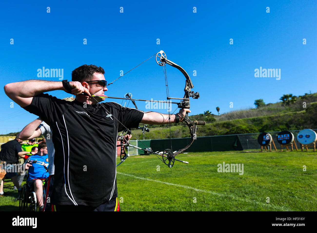 Gavin Bolger, a British Royal Marine Commando draws his bow and takes ...