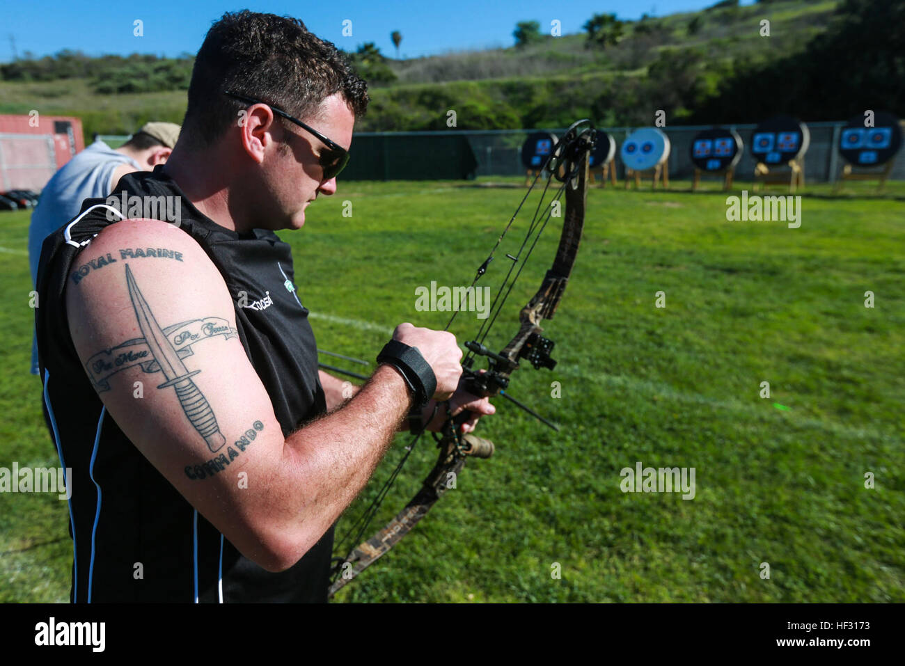 Gavin Bolger, a British Royal Marine Commando readies an arrow with his ...