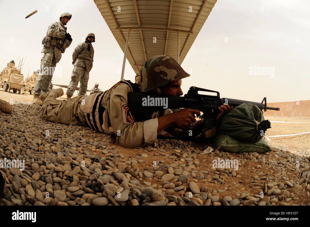An Iraqi soldier fires his M-16 rifle during a weapons qualification ...