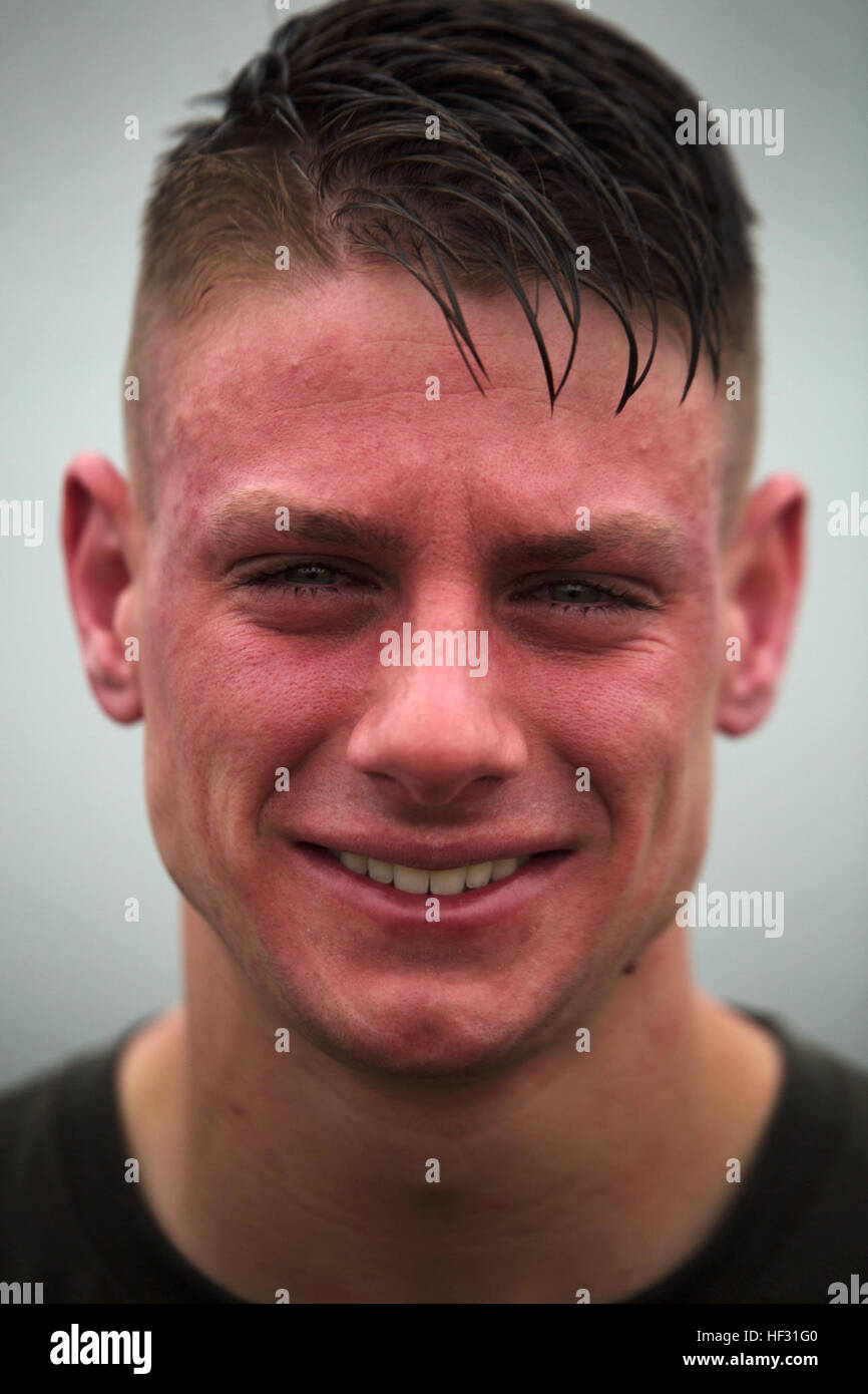 Lance Cpl. Ryan Reuscher poses for a photo and attempts a smile after ...