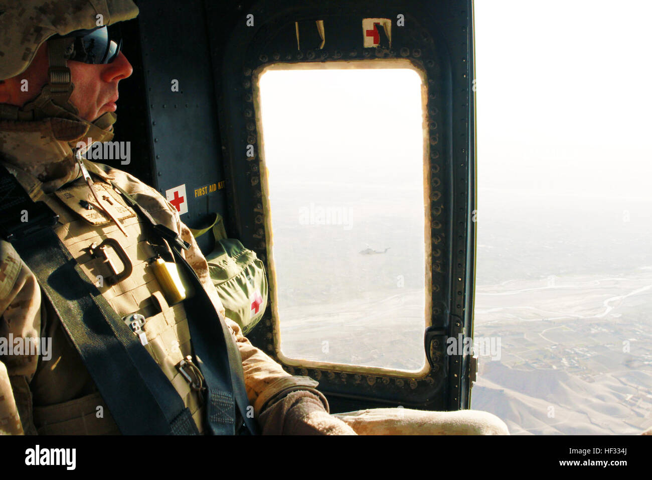 With a Marine Corps AH-1W Cobra helicopter (in the distance) as escort ...