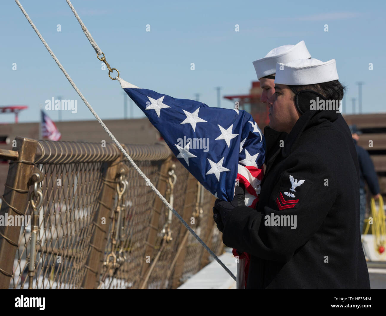 Sailors aboard USS Arlington raise the colors upon arrival at Black ...