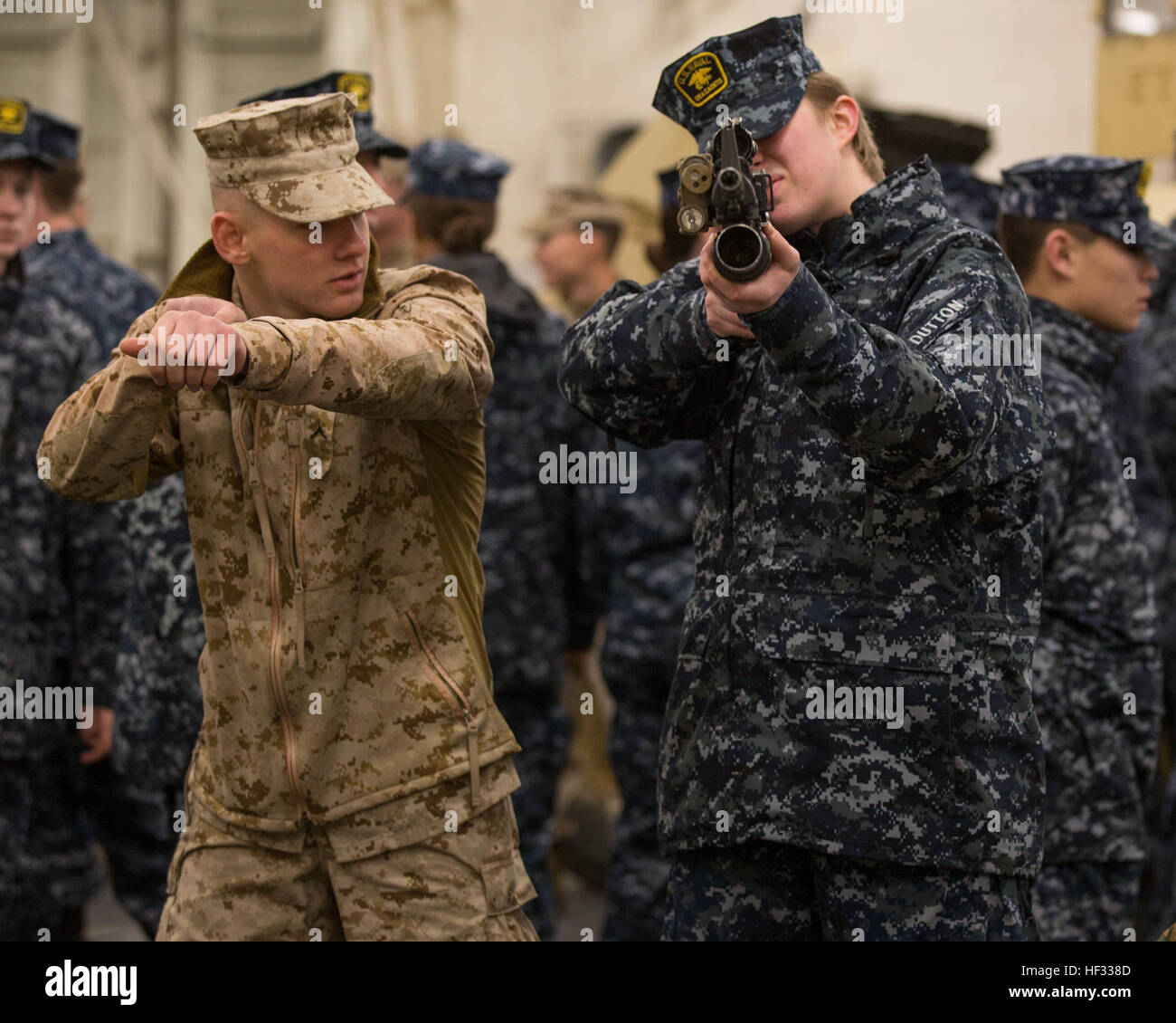A U.S. Naval Sea Cadet sights in with an M16A4 service rifle with a ...