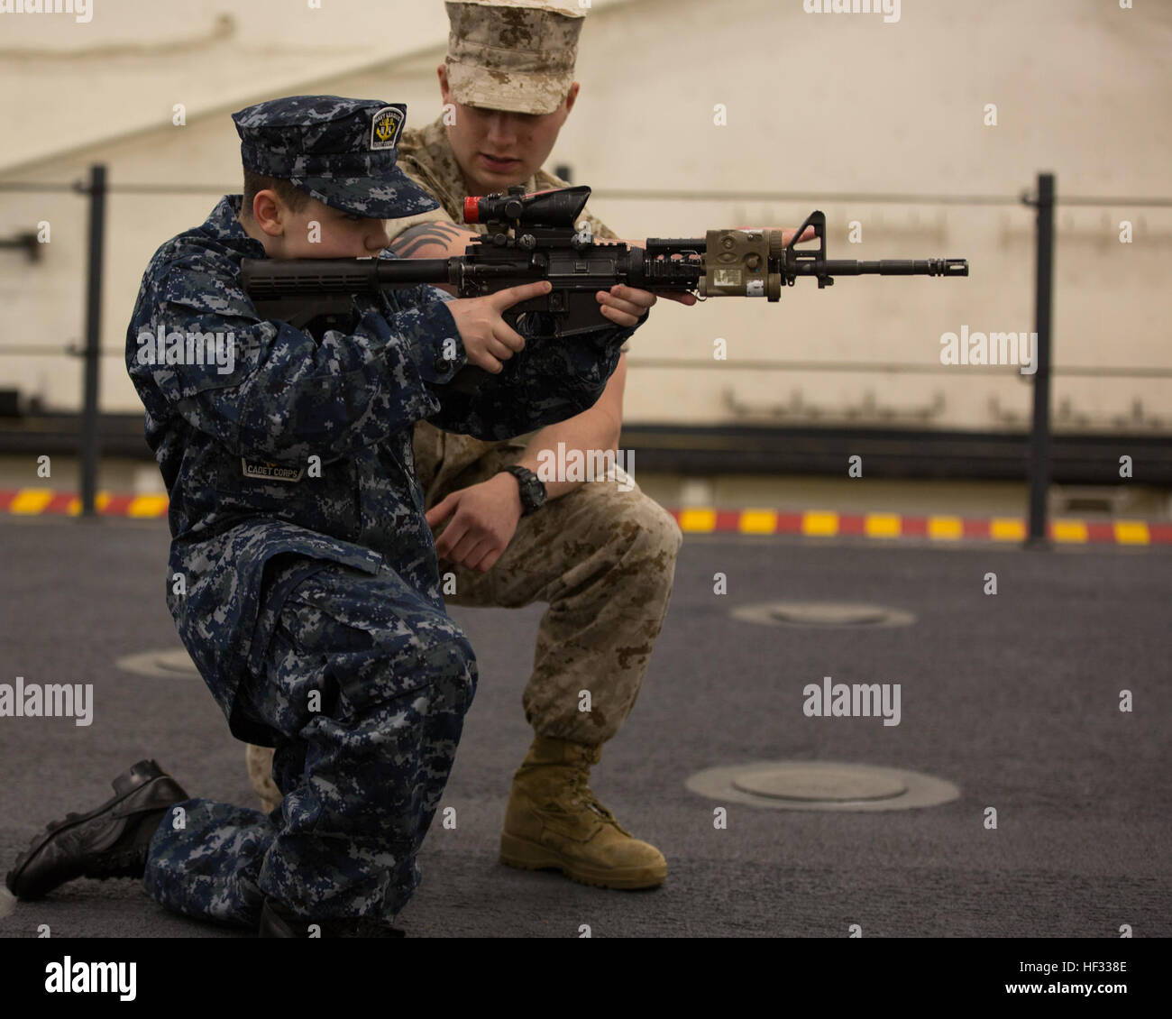 A U.S. Naval Sea Cadet looks through the sight of a M4A1 service rifle ...