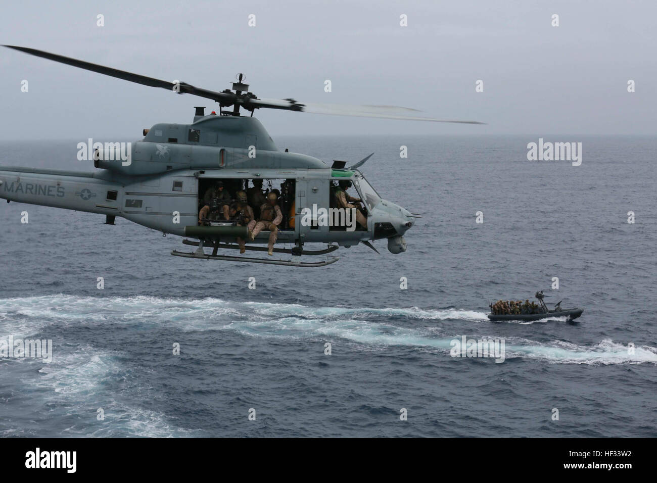 A UH-1Y Venom and a rigid-hull inflatable boat transport U.S. Marines ...