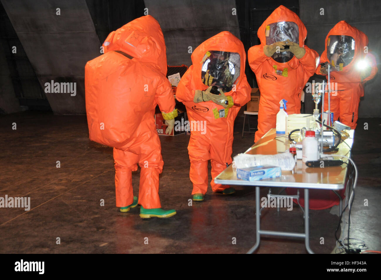 Members of the Air National Guard work in a clandestine lab to find the ...