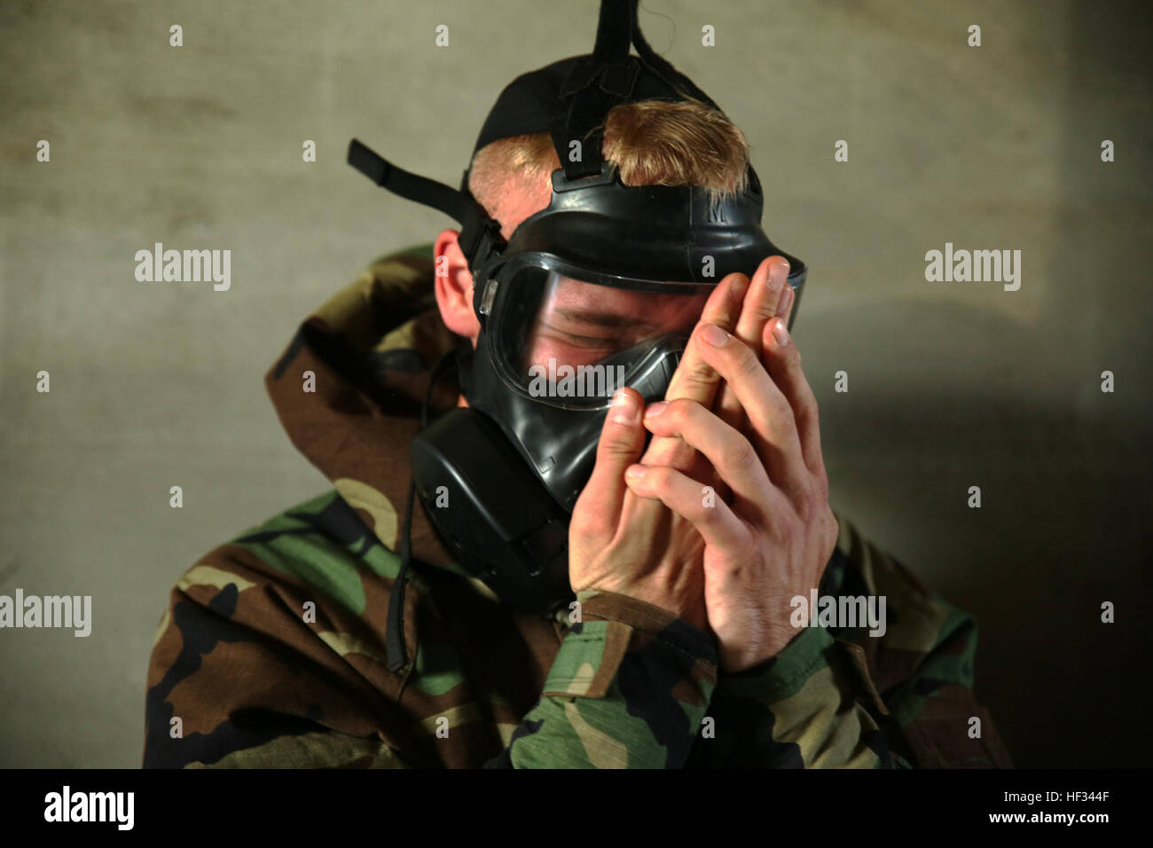 A U.S. Marine Corps Forces, Pacific Marine clears his gas mask during ...