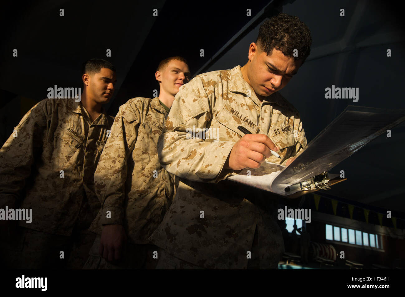 U.S. Marines with Combat Logistics Battalion 2, sign their names in an ...