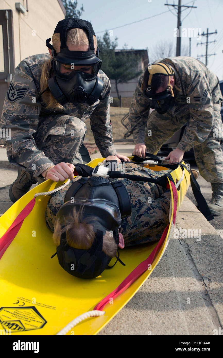 U.S. Marines and airmen extract a simulated casualty at Osan Air Base ...