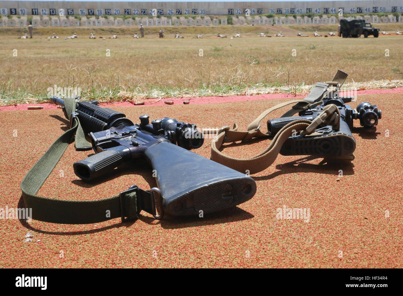 The M16A4 service rifle, donning the web sling, lies next to an M4 ...
