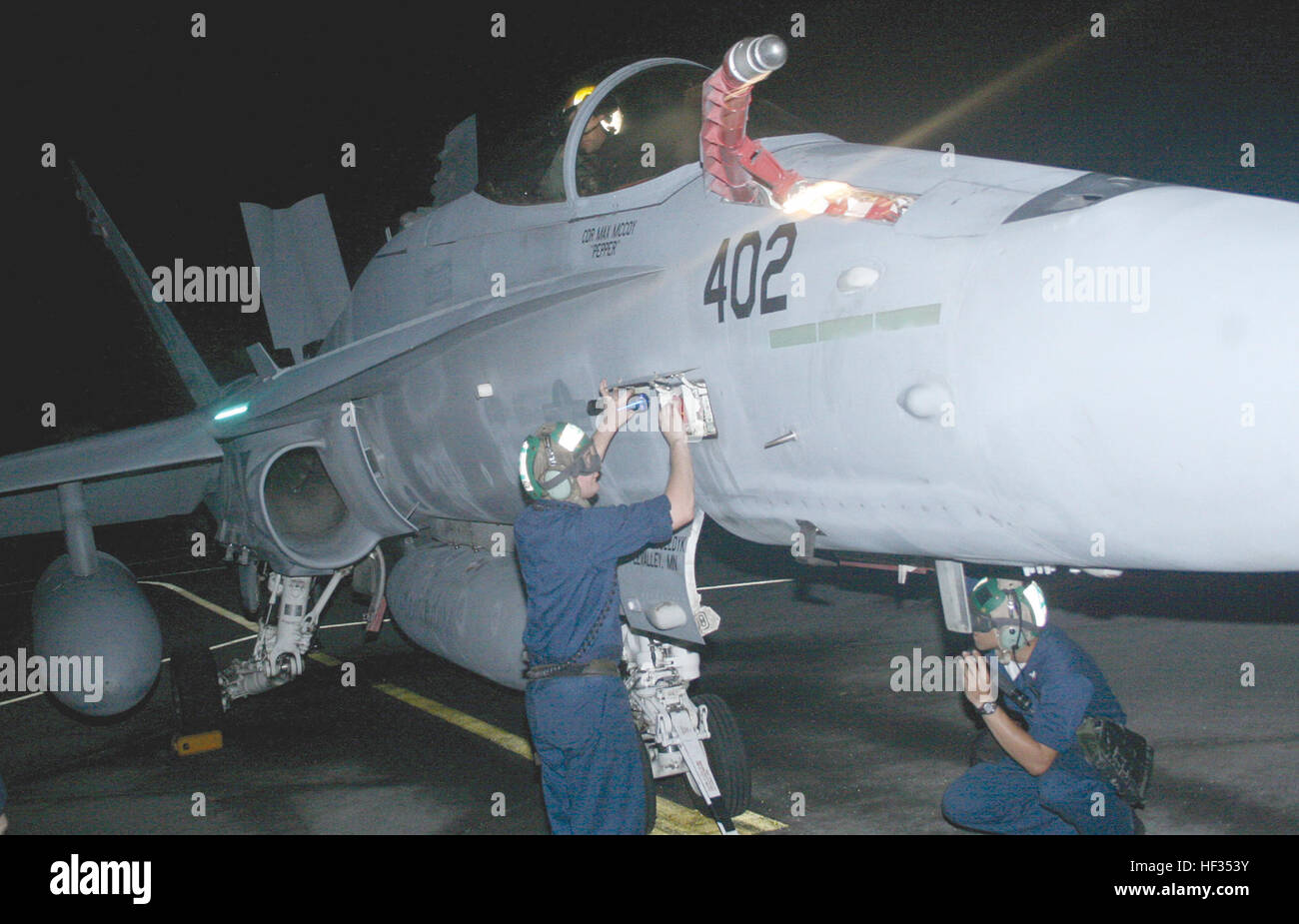 Sailors with the Navy Strike Fighter Squadron 86 do final touchups ...