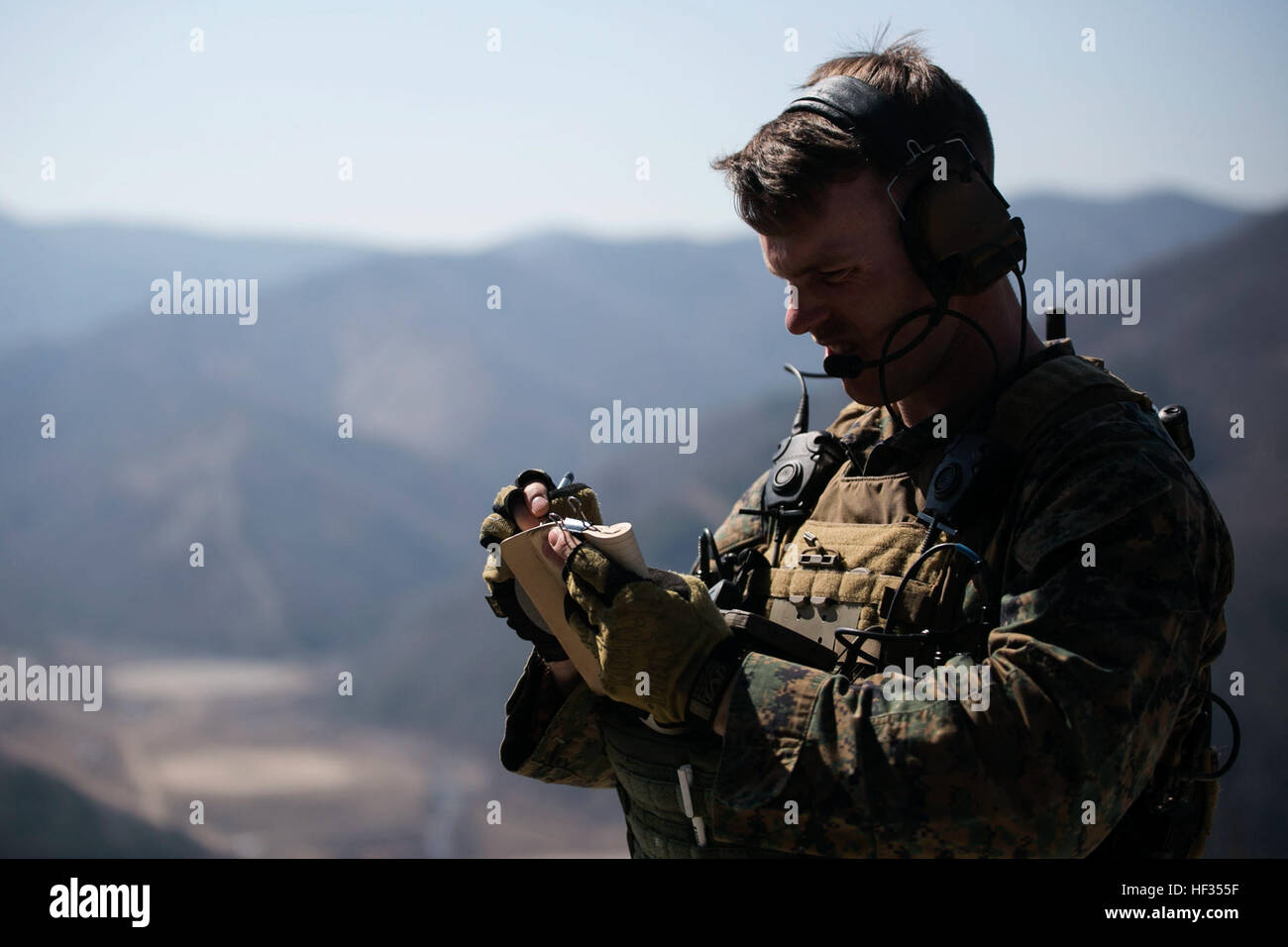 U.S. Marine Capt. Joseph R. Mozzi takes notes March 26 at Pilsung Range ...