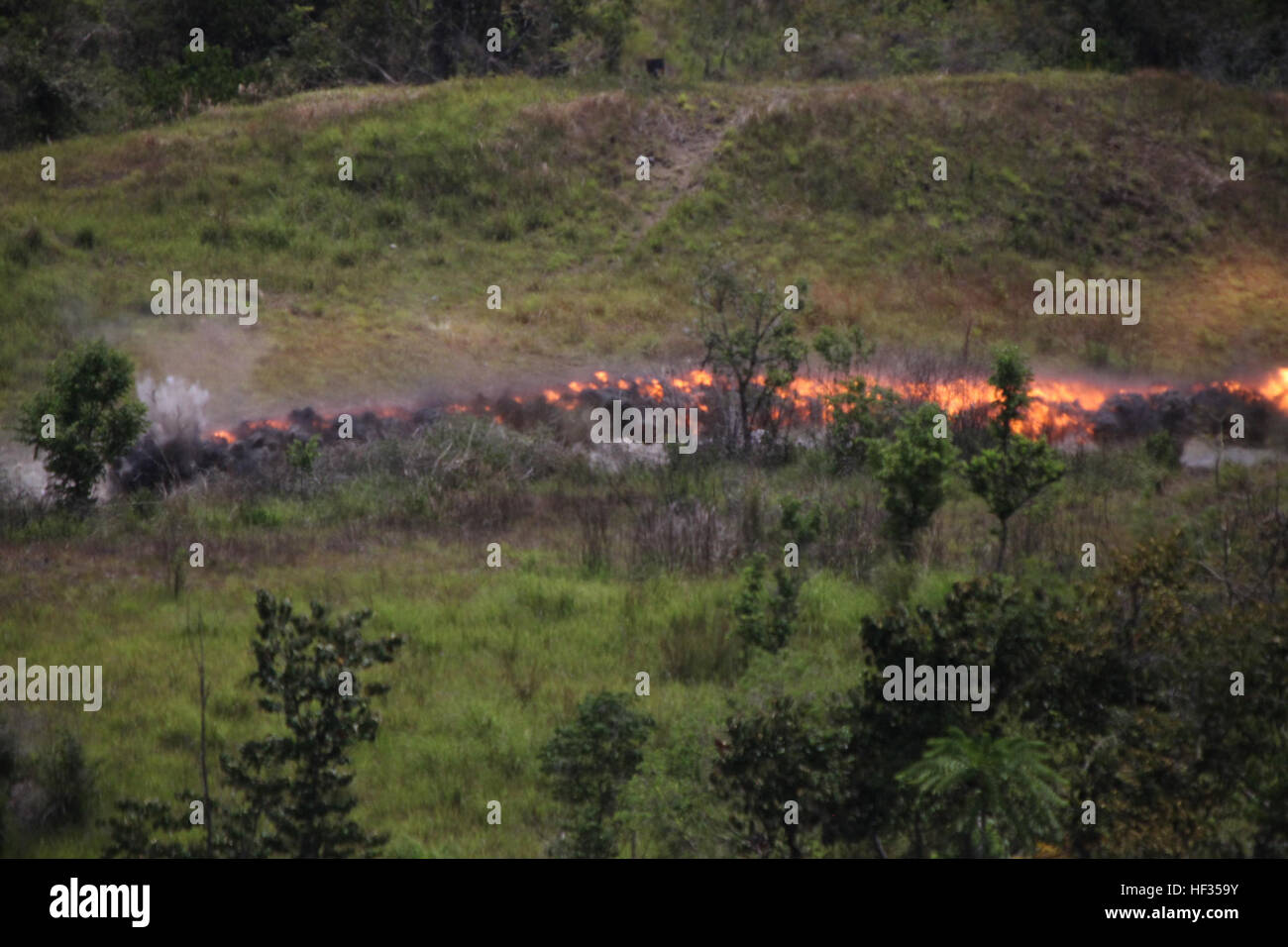 The explosion from an anti-personnel obstacle breaching system erupts ...