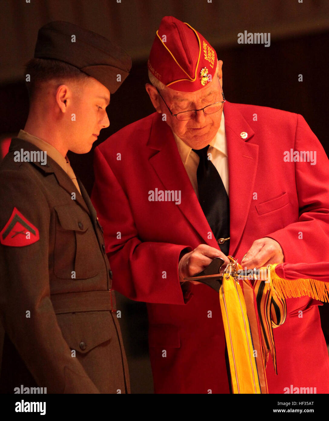 A Marine and member of the Second Marine Division Association attach a ...