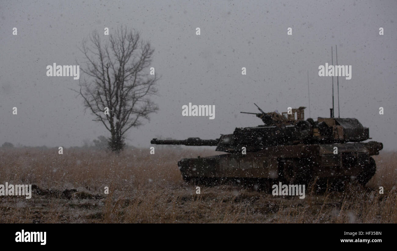 An Abrams Main Battle Tank idles in a snow-covered field while the ...