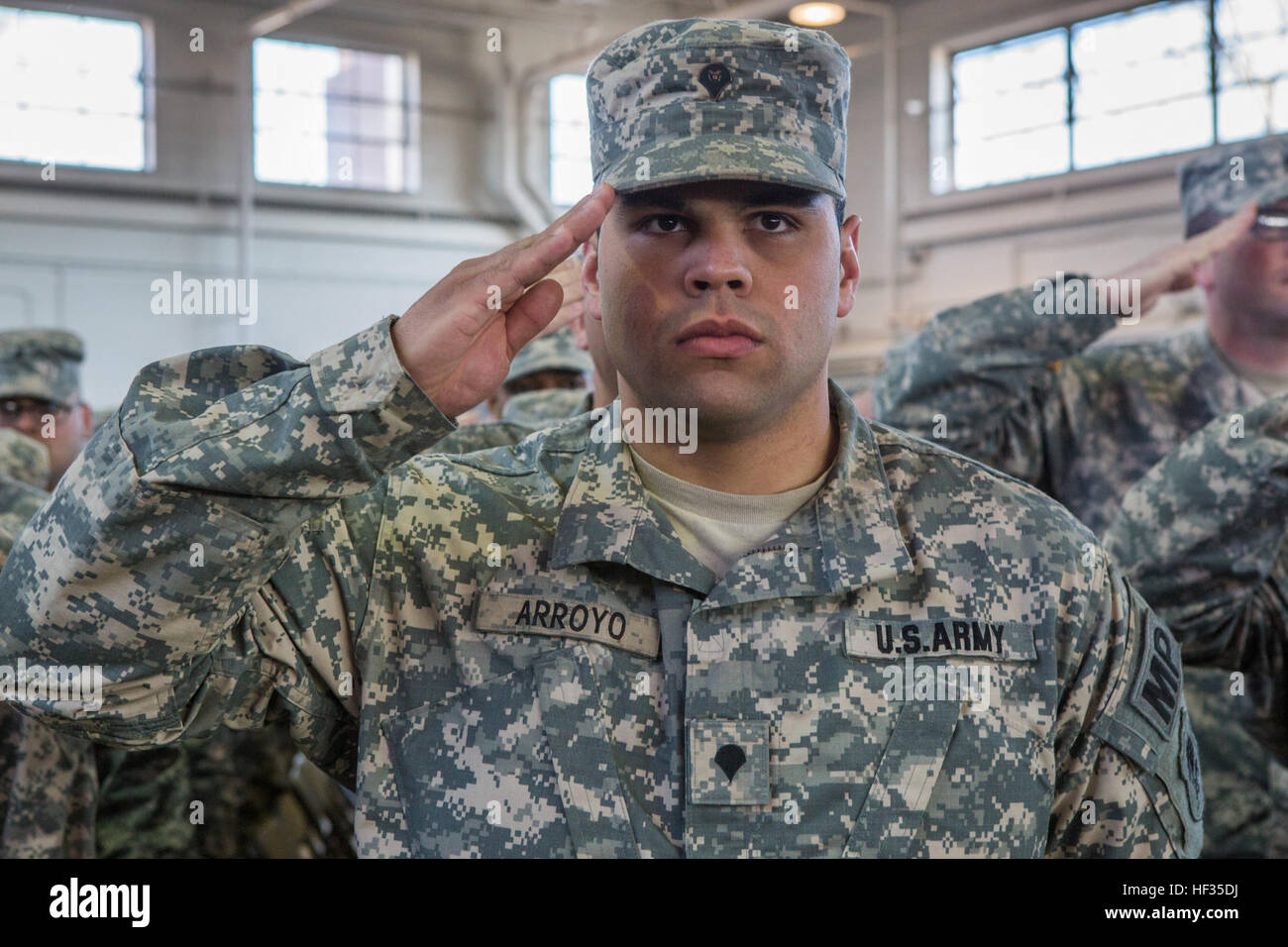 Spc. Jose G. Arroyo salutes during the playing of the National Anthem ...