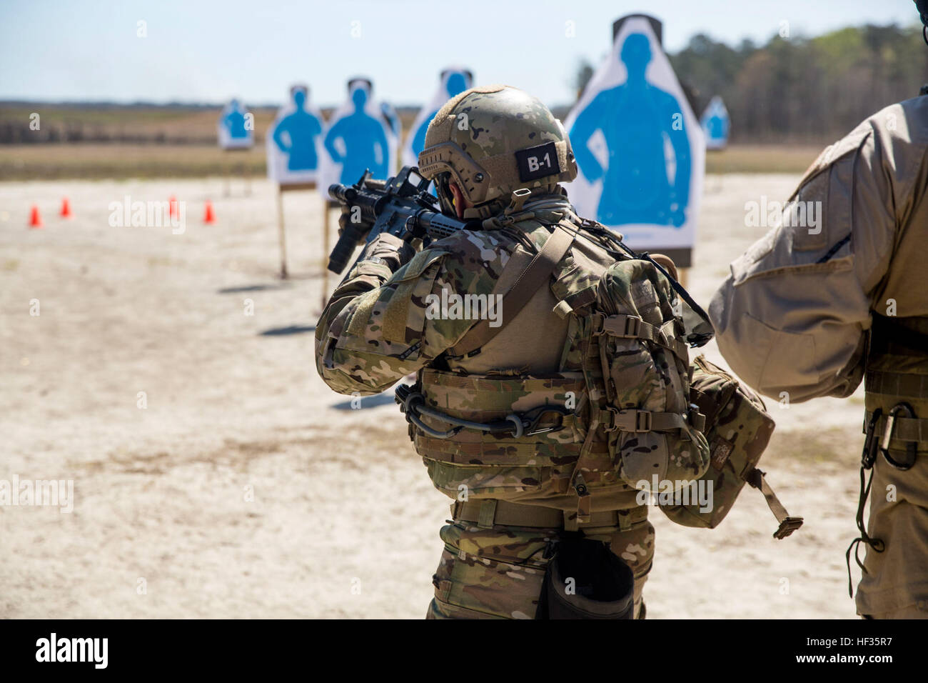 A Deployable Specialized Forces U.S. Coastguardsman fires an Mk18 rifle ...