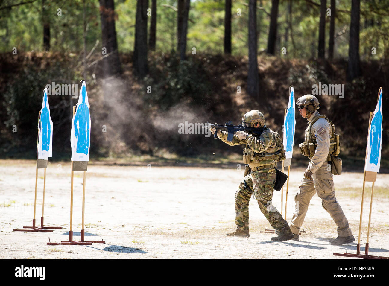 A Deployable Specialized Forces U.S. Coastguardsman fires an Mk18 rifle ...