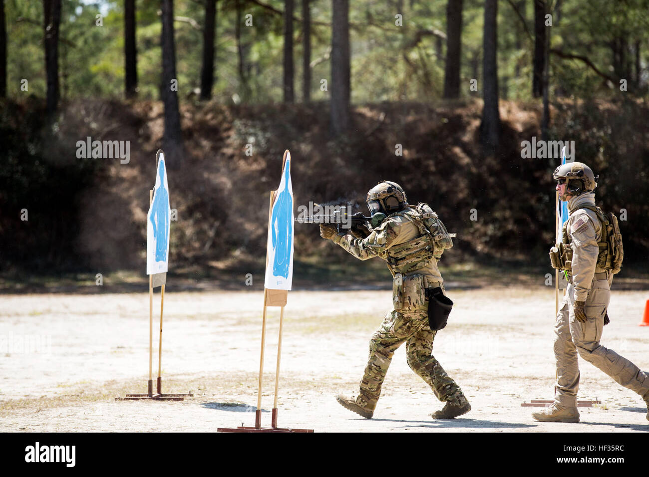 A Deployable Specialized Forces U.S. Coastguardsman fires an Mk18 rifle ...