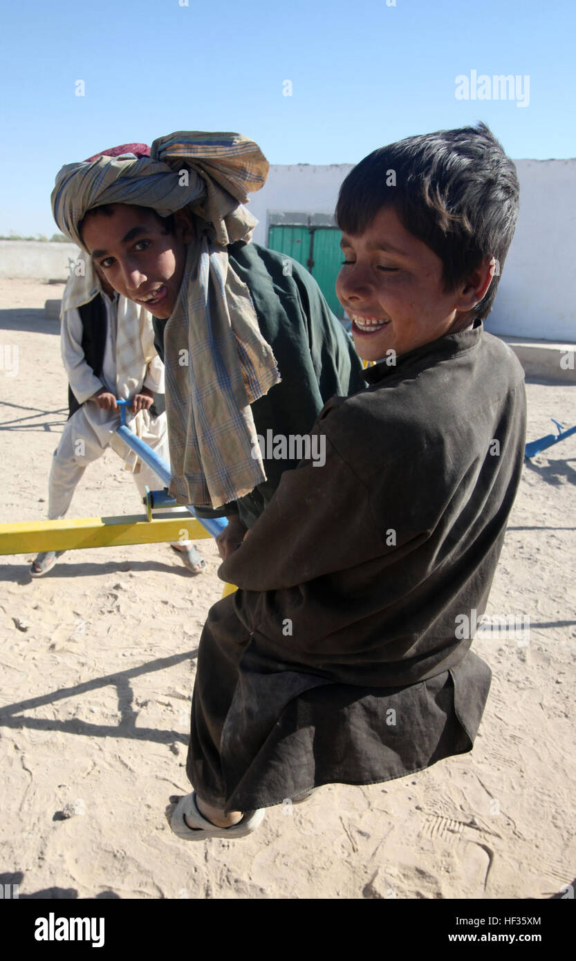 Children play inside the courtyard of a school built by coalition ...