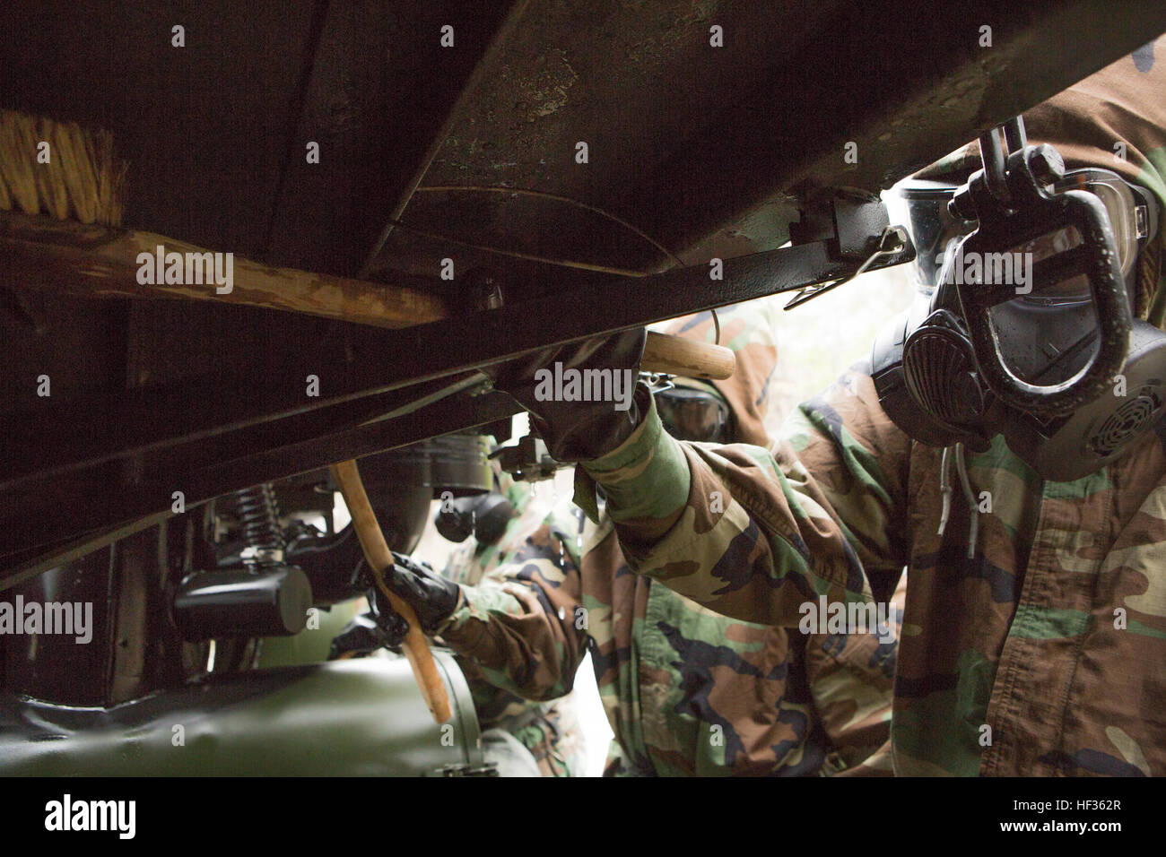 U.S. Marines assigned to Marine Aircraft Group 14 decontaminates a ...