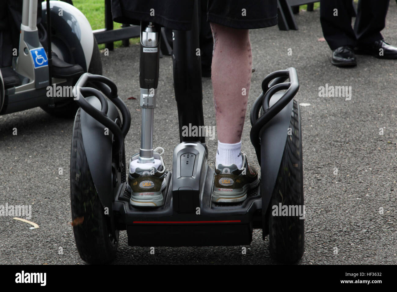 A wounded warrior rides the Segway across the stage to demonstrate the ...