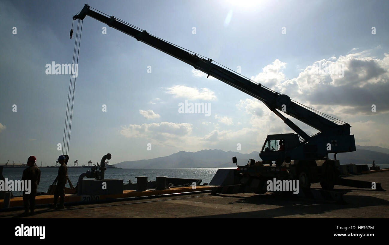 U.S. Marines and Sailors move essential utility and motor ...