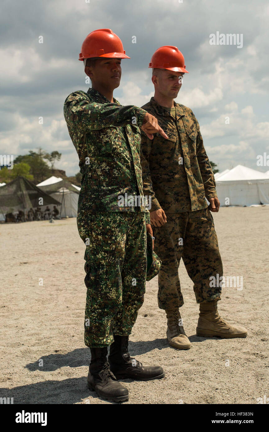 Philippine and U.S. Marines use hand and arm signals to guide a 20-ton ...