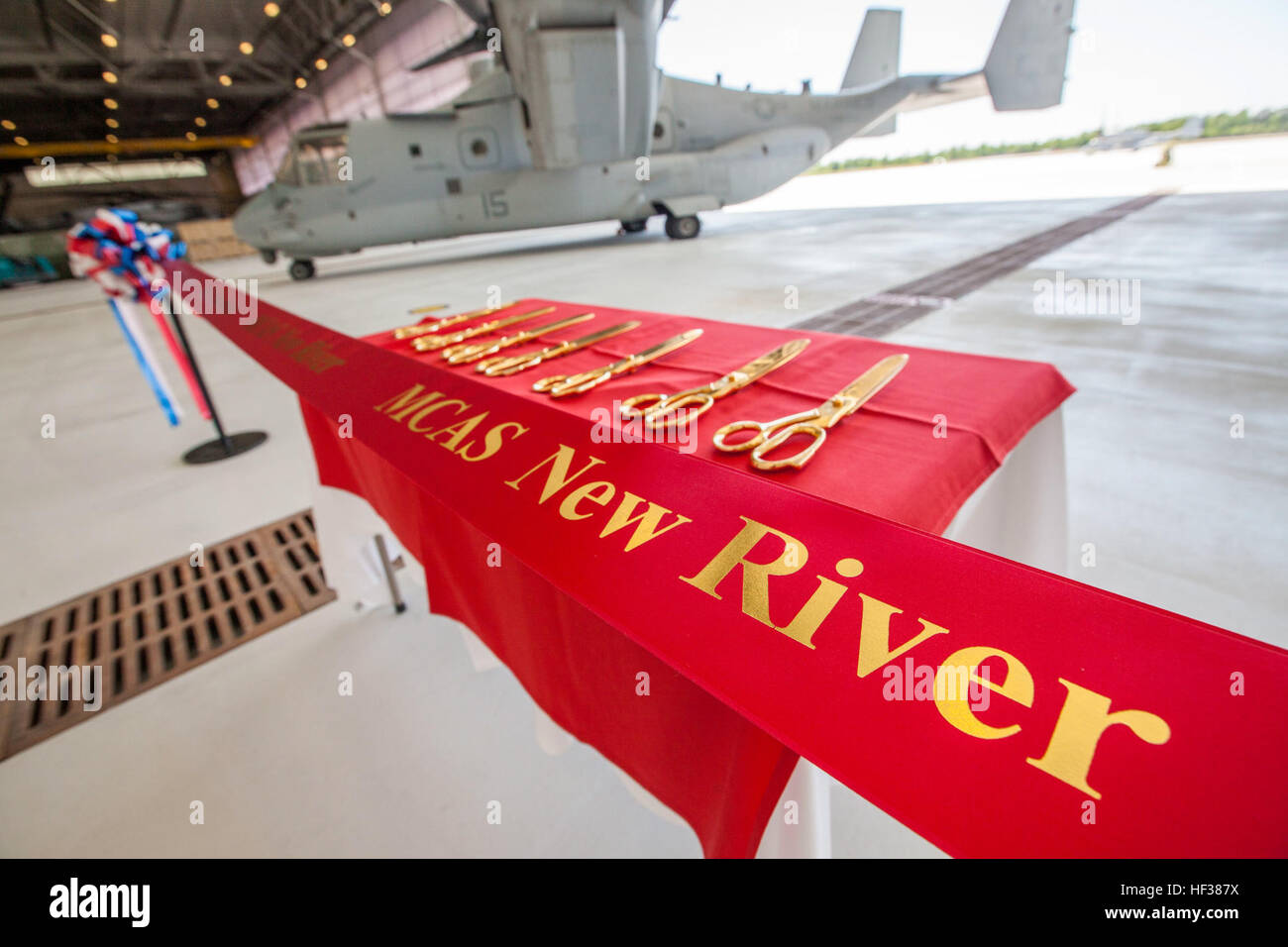 A ribbon and scissors are displayed on a table prior to a ribbon ...