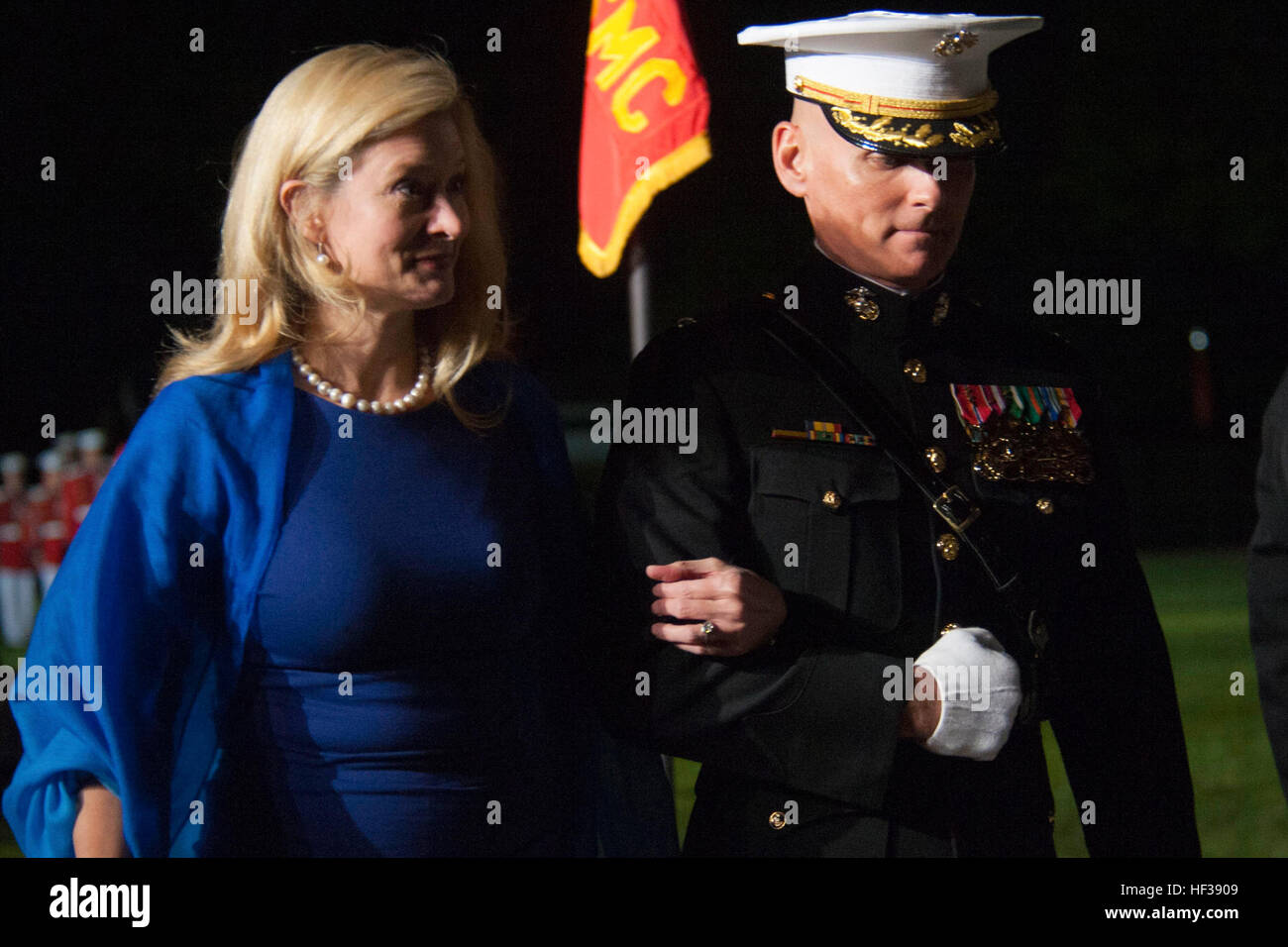 A U.S. Marine escorts Lynne Mabus, wife of Secretary of the Navy Ray E ...