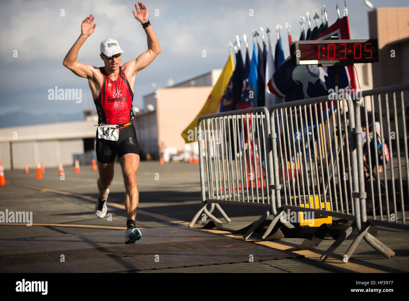 Michael Gabiga puts his hands up as he runs through the finish line at ...