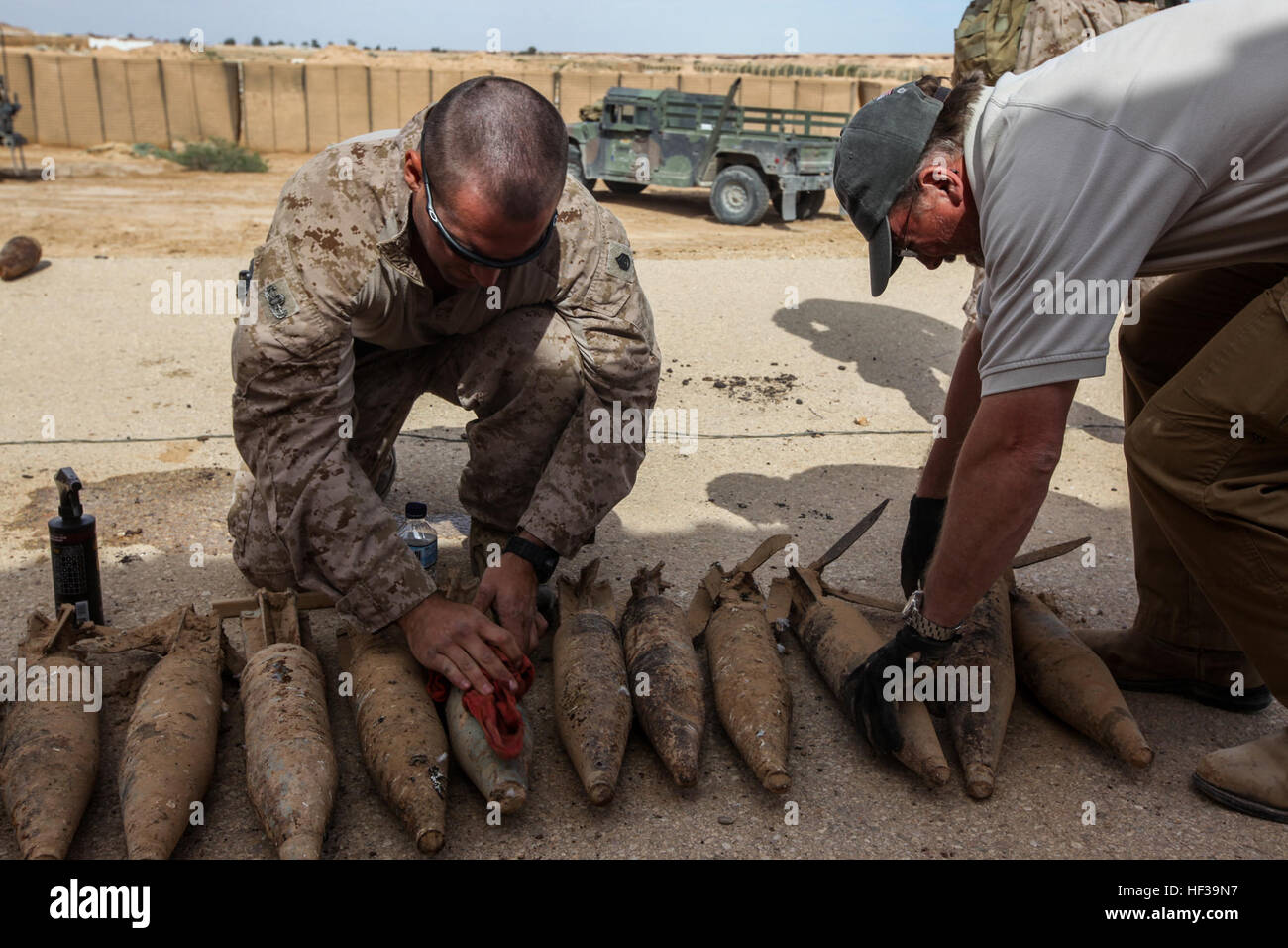 U.S. Marine Staff Sgt. Brewer (left), an explosive ordnance disposal ...