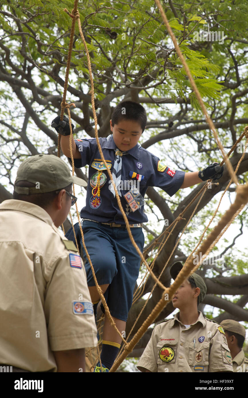 Cub Scout James Lau crosses a 70-foot-long one-rope bridge during the ...