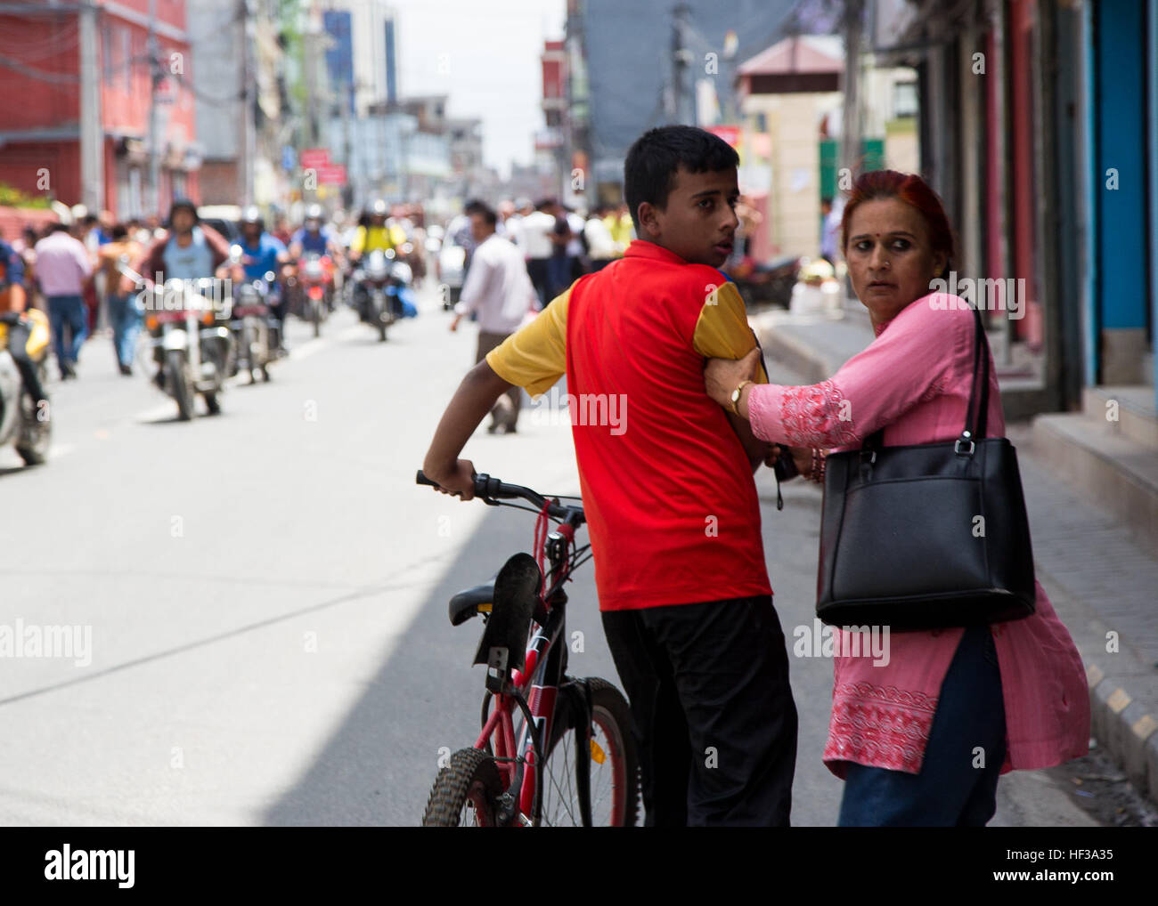 Nepalese citizens race into the streets of Kathmandu, Nepal, in response to a 7.3 magnitude ...