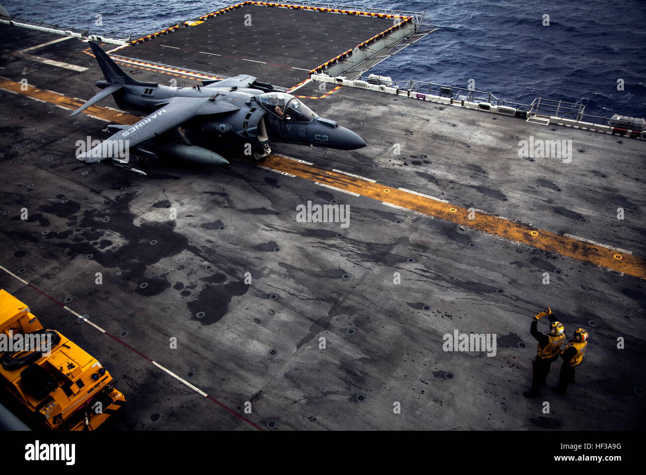U.S. Sailors with the Essex Amphibious Ready Group signal to the pilot ...