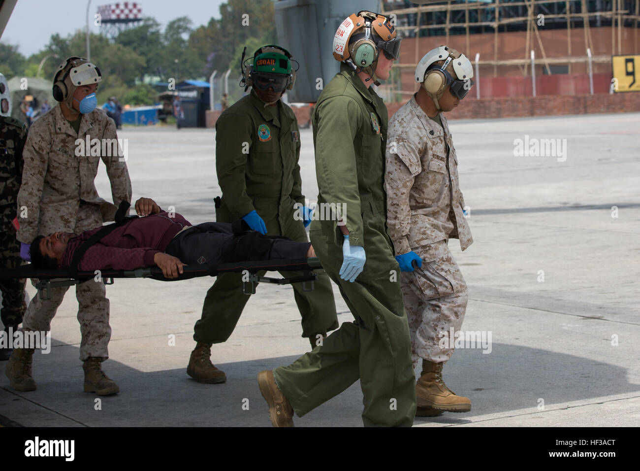 U.S. Service members transport an earthquake victim from an MV-22 ...