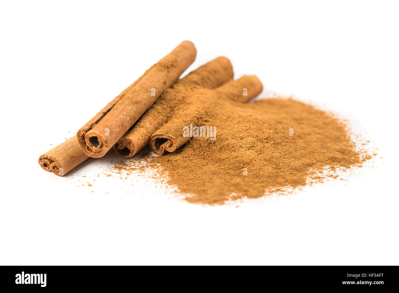 Stack of cinnamon sticks and ground cinnamon isolated on white ...