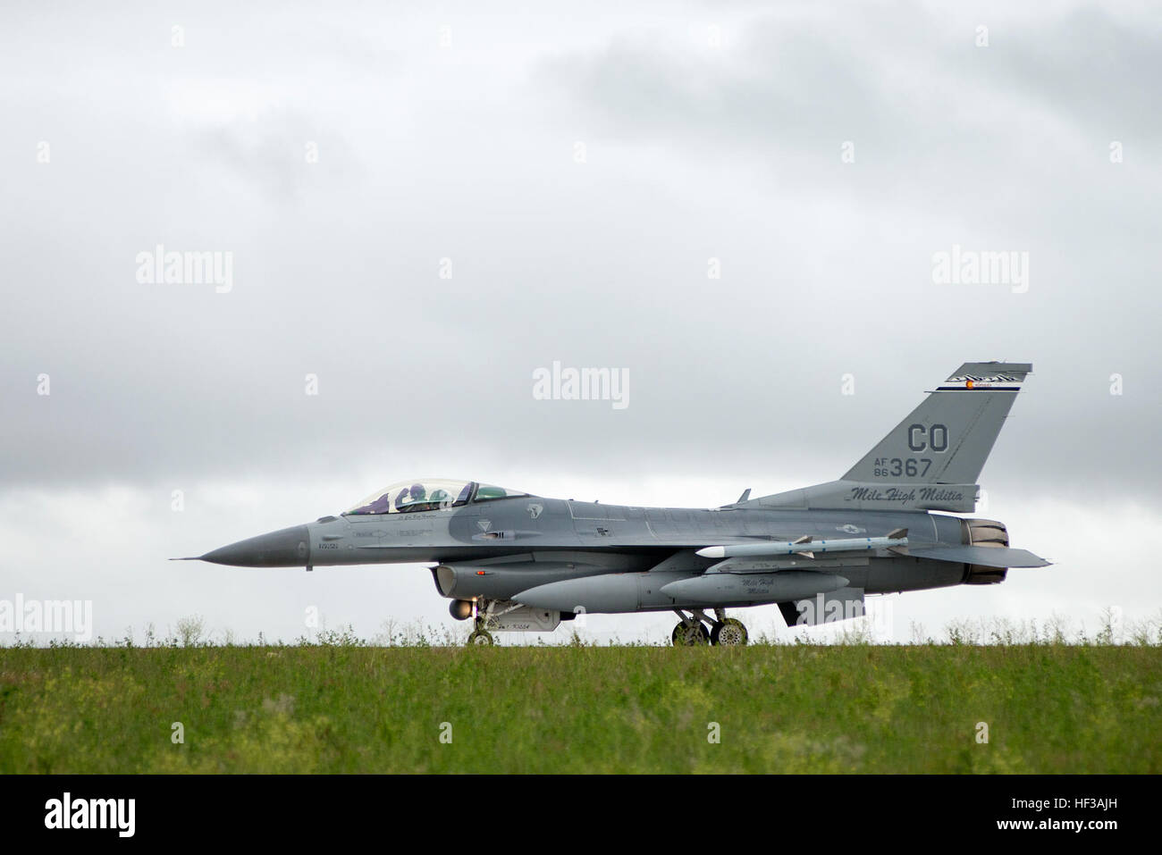 U.S. Air Force Lt. Col. Kurt Tongren waives to his family as he taxis ...