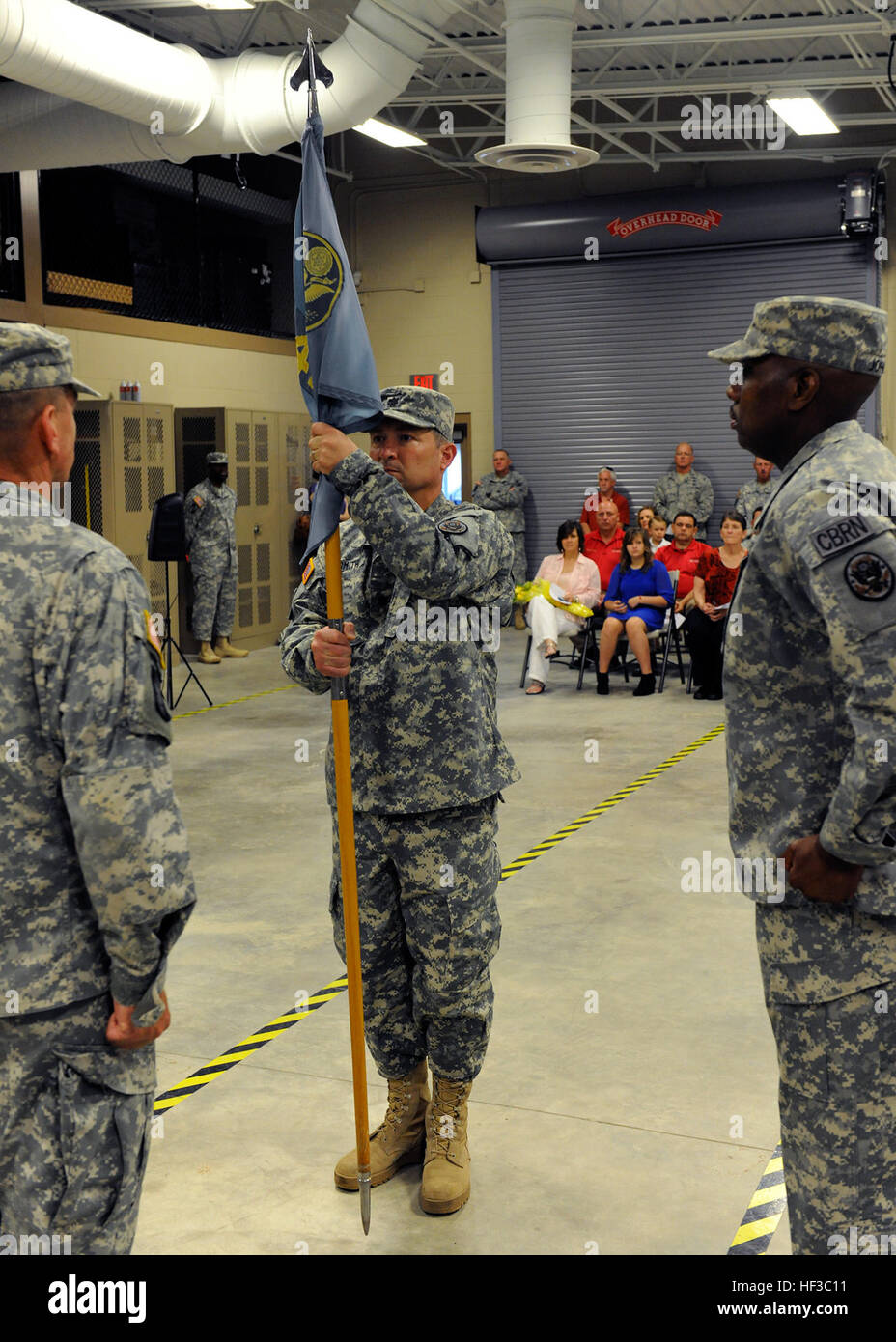 Lt. Col. Anthony W. Smith, of Wiggins, holds the unit colors while the ...