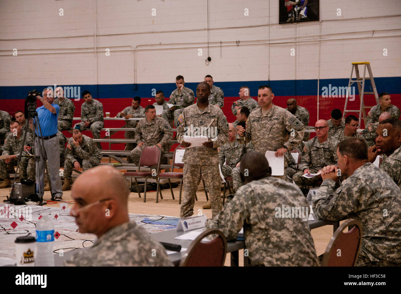 Soldiers from the 36th Infantry Division gather by a map board for a ...