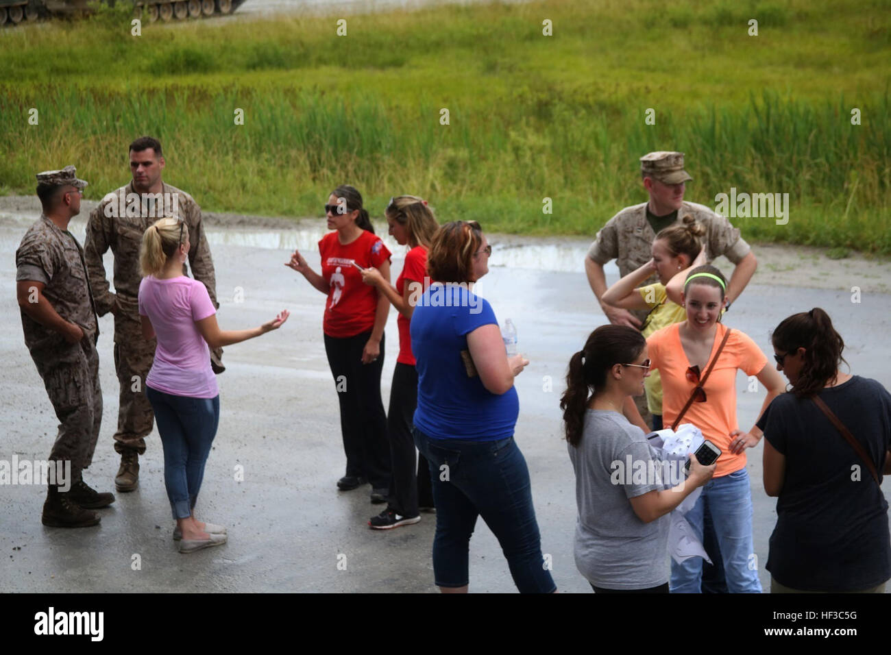 Marines and spouses socialize while waiting to ride on an M1A1 Abrams ...