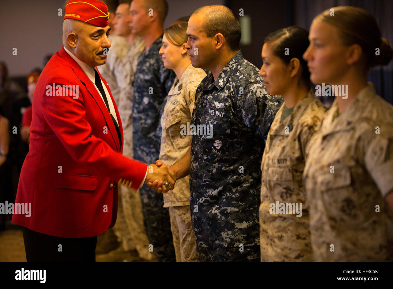 A representative with the Marine Corps League congratulates Marines and ...