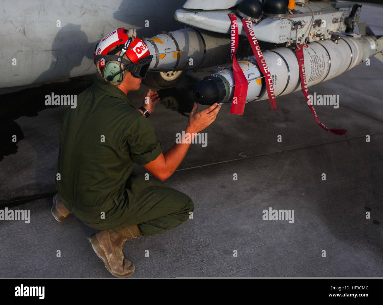 A U.S. Marine aviation ordnance technician with Marine Fighter Attack ...