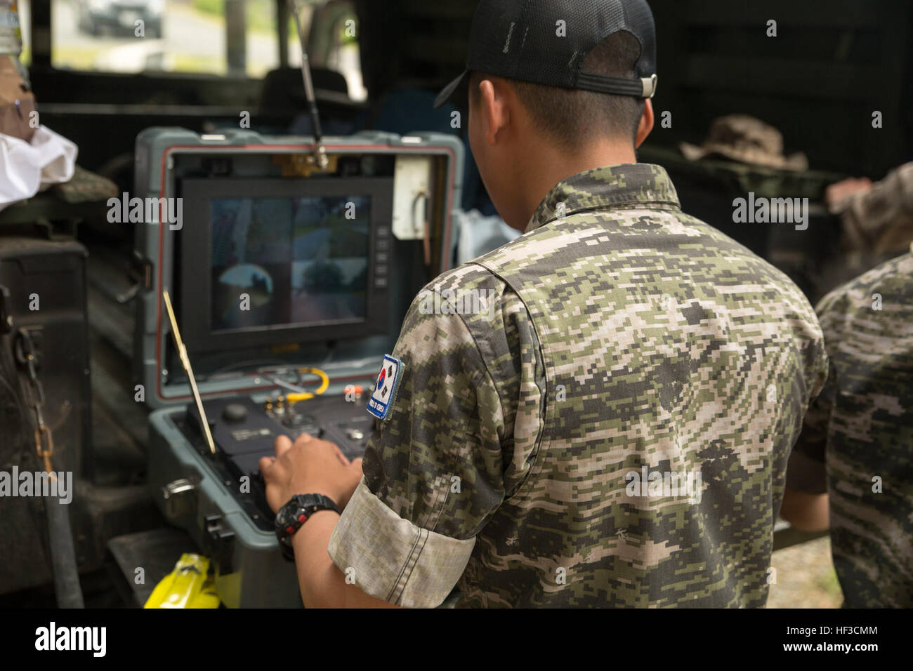 Republic of Korea Marine Cpl. Yung Hoon Kim uses an operator control ...