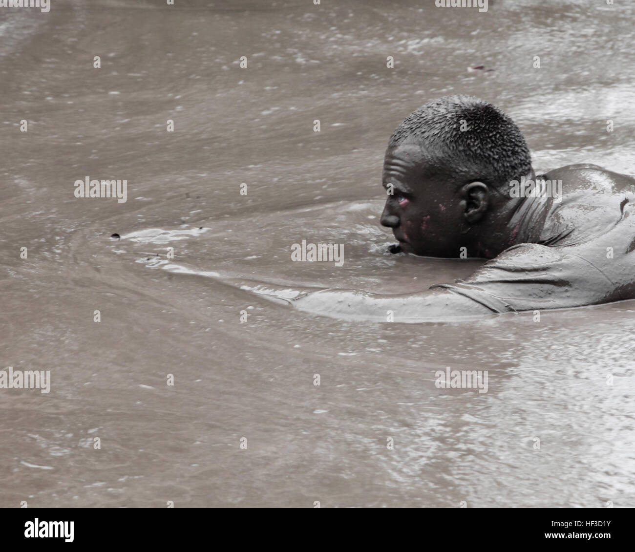 A participant swims through a mud pit during the Commanding General’s ...