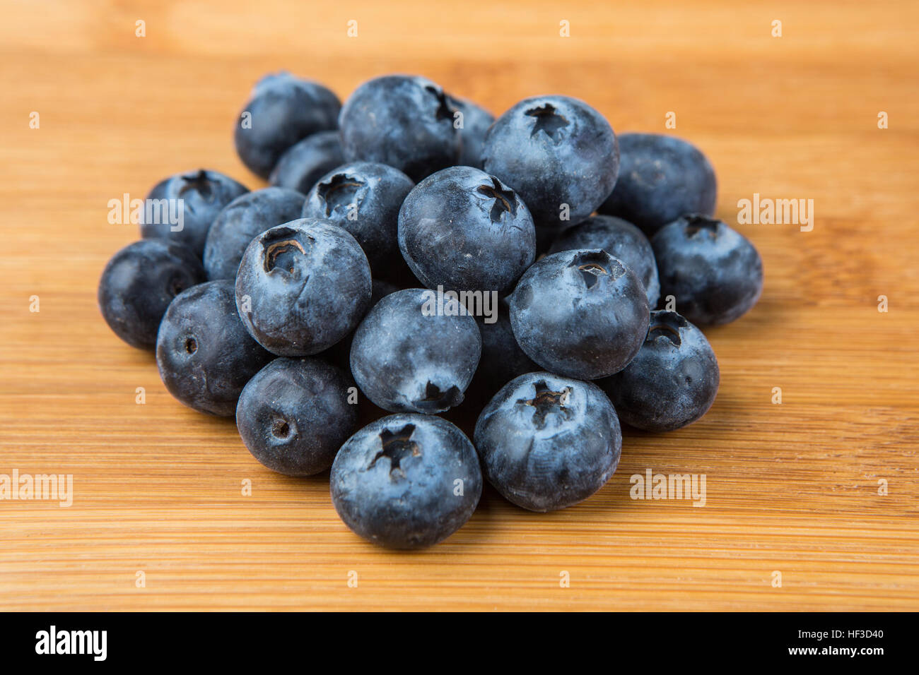 Pile of blueberries isolated on wood background Stock Photo - Alamy