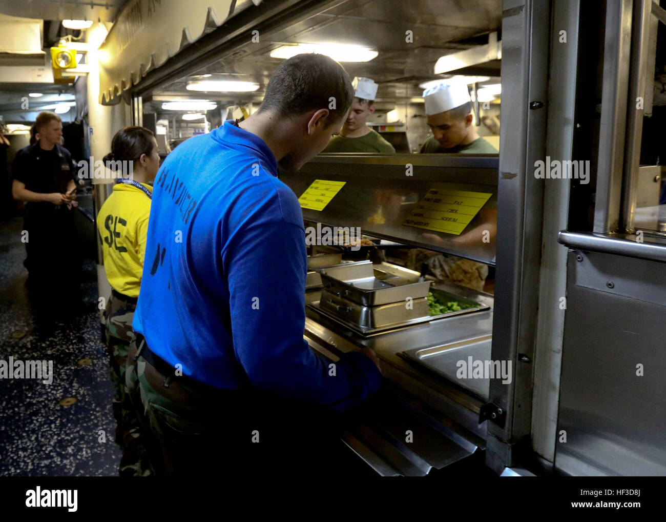 U.S. Navy Sailors with Amphibious Squadron (PHIBRON) 4 are served lunch ...