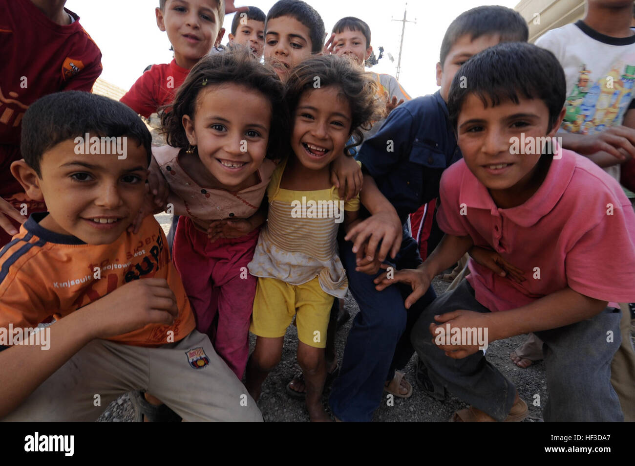 Iraqi children gather around a combat camera photographer, as they ...