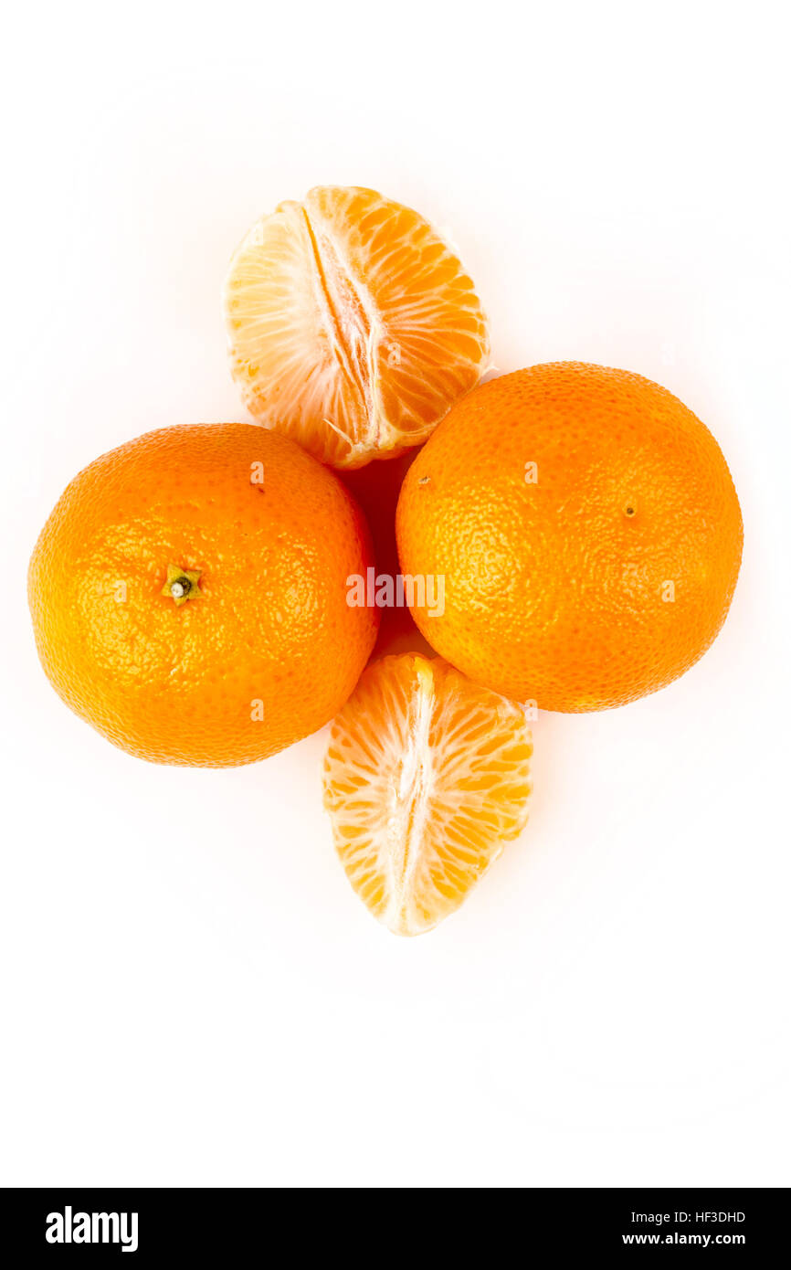 Three navel oranges one peeled two unpeeled isolated on white ...